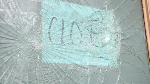 Closed sign of business behind broken gl... | Stock Video | Pond5