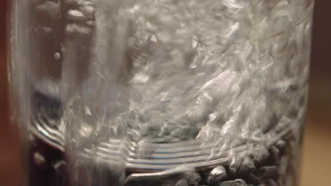 Closeup of a boiling liquid in a flask i... | Stock Video | Pond5