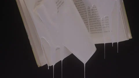 Closeup of a Book Dripping White Paint i... | Stock Video | Pond5
