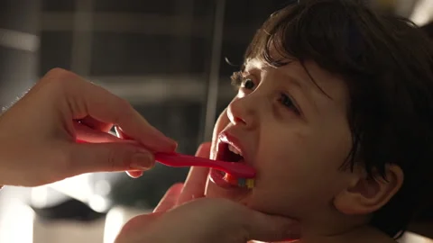 Closeup child face brushing teeth at nig... | Stock Video | Pond5