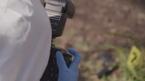Closeup of a Crime Scene Investigator Ta... | Stock Video | Pond5
