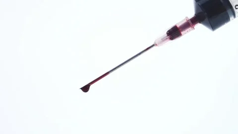 Closeup drop of blood from a syringe on ... | Stock Video | Pond5