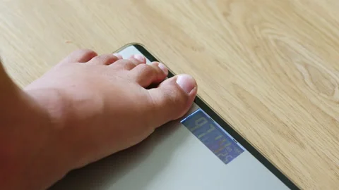 Closeup fat man step on scales to measur... | Stock Video | Pond5
