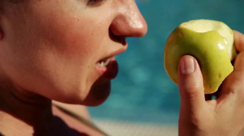 Closeup of female mouth biting apple wit... | Stock Video | Pond5