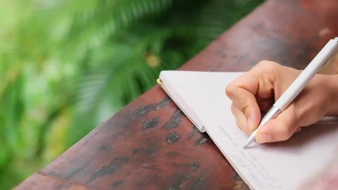 closeup of a hand journaling on a table ... | Stock Video | Pond5