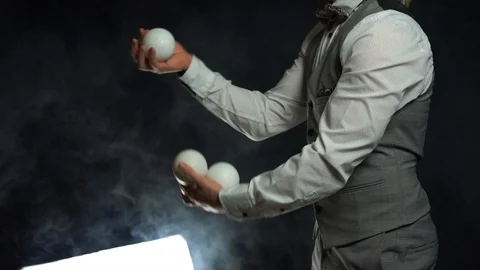 Closeup of hands in suit juggling white ... | Stock Video | Pond5