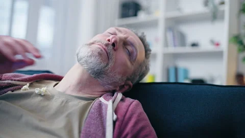 Closeup of man sleeping in front of TV, ... | Stock Video | Pond5