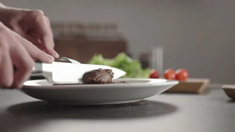 Closeup man slicing steak on white plate... | Stock Video | Pond5