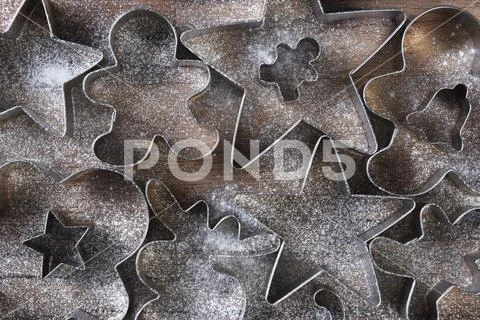 Closeup overhead view of a group of assorted cookie cutters in various ...