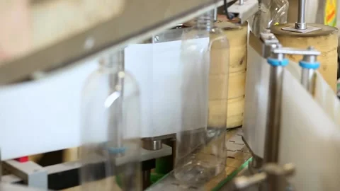 A closeup of plastic bottles being label... | Stock Video | Pond5