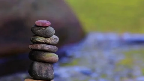 Closeup of stacked stones by the river a... | Stock Video | Pond5