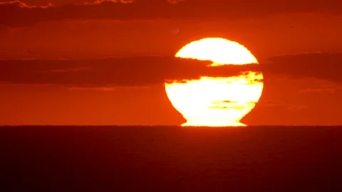 Closeup of a sunrise as the sun rips awa... | Stock Video | Pond5