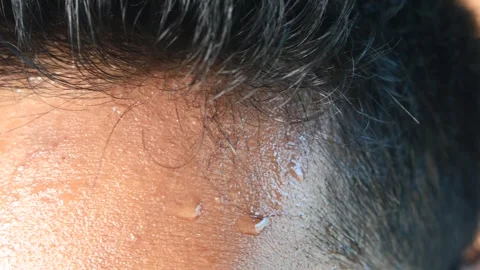 closeup of sweat on forehead against dar... | Stock Video | Pond5