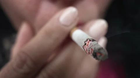 Closeup woman hand smoking cigarette ,un... | Stock Video | Pond5