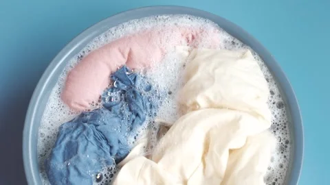 Clothes soaked with powder in a basin on... | Stock Video | Pond5