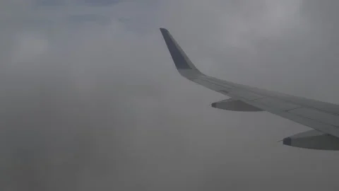Clouds from aircraft window in a bumpy r... | Stock Video | Pond5