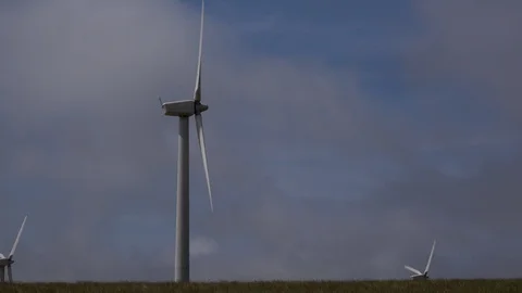 Clouds moving fast and wind Turbine in f... | Stock Video | Pond5
