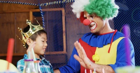 Clown giving high five to boy during bir... | Stock Video | Pond5