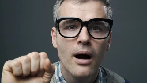 Clueless nerd guy knocking on the screen | Stock Video | Pond5