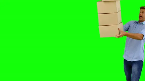 Clumsy man dropping boxes down on green ... | Stock Video | Pond5