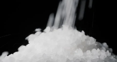 Coarse-grained salt is poured into a pil... | Stock Video | Pond5