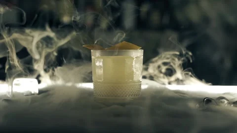 Cocktail with dry ice on the bar | Stock Video | Pond5
