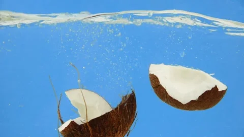 Coconut falling into a water with splash... | Stock Video | Pond5