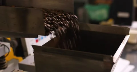 Coffee beans are poured into the metal h... | Stock Video | Pond5