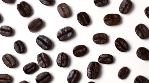 Coffee beans dancing on white background... | Stock Video | Pond5