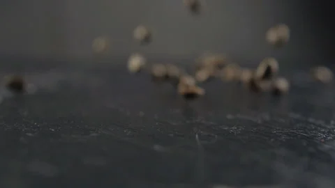 Coffee beans thrown against black backgr... | Stock Video | Pond5