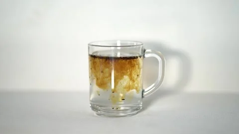 The coffee dissolves in water. Isolated ... | Stock Video | Pond5