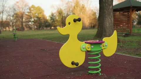 Coil spring playground rocker in empty p... | Stock Video | Pond5