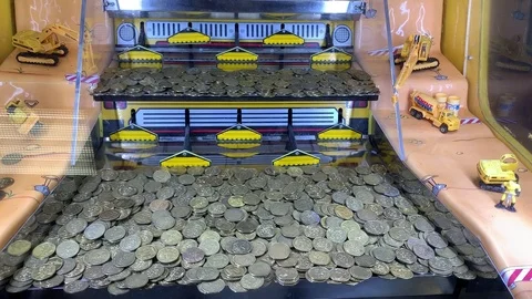A coin pusher game filled with tokens at... | Stock Video | Pond5