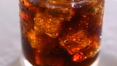 Coke with ice cubes background. Rotation... | Stock Video | Pond5
