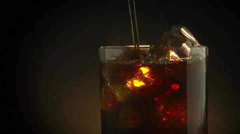 coke pour over ice. chiaroscuro lighting | Stock Video | Pond5