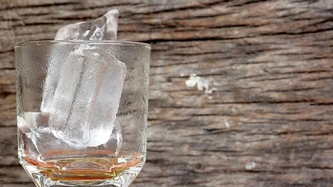 Cola drop in glass on old backgrounds | Stock Video | Pond5