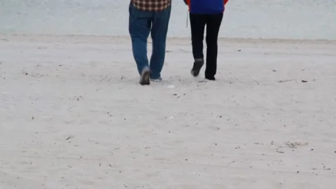 Cold Day on The Beach Couple Walking Tog... | Stock Video | Pond5