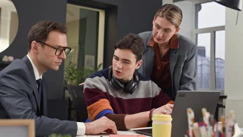 Colleagues Helping Young Newcomer with W... | Stock Video | Pond5