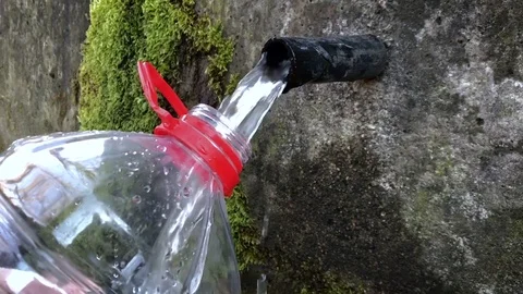 Collecting fresh drinking water in the p... | Stock Video | Pond5