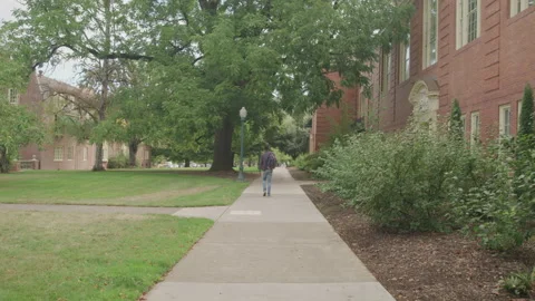 College Student Walking Through Campus | Stock Video | Pond5