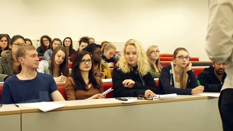College Students passing a note in class... | Stock Video | Pond5