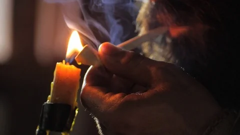 Colonial Man lights clay pipe by candle ... | Stock Video | Pond5