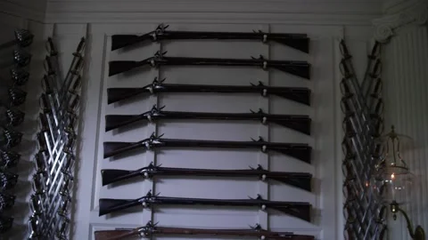 Colonial rifle guns in a row on a wall b... | Stock Video | Pond5