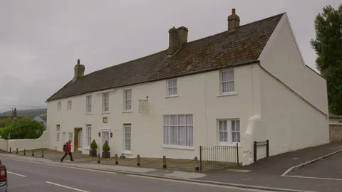 A colonial-style inn located by the side... | Stock Video | Pond5