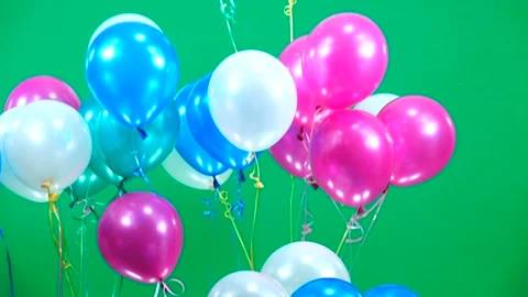 color balloons fly up on the green scree... | Stock Video | Pond5