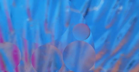 Color drops floating in oil and water wi... | Stock Video | Pond5