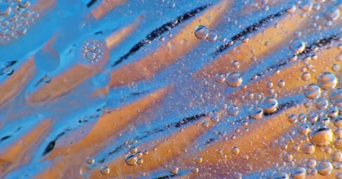 Color drops floating in oil and water wi... | Stock Video | Pond5