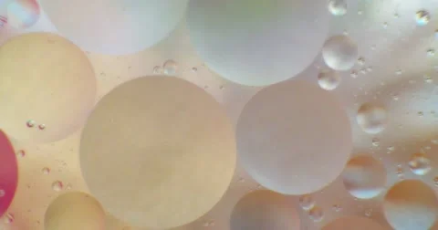 Color drops floating in oil and water wi... | Stock Video | Pond5