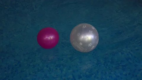 Colorful balls float in swimming pool wa... | Stock Video | Pond5