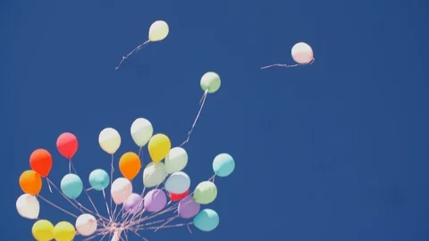 Colorful balls flying away in clear blue... | Stock Video | Pond5